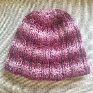 Ravelry: Loom Knit Cabled Beanie pattern by Faith Schmidt